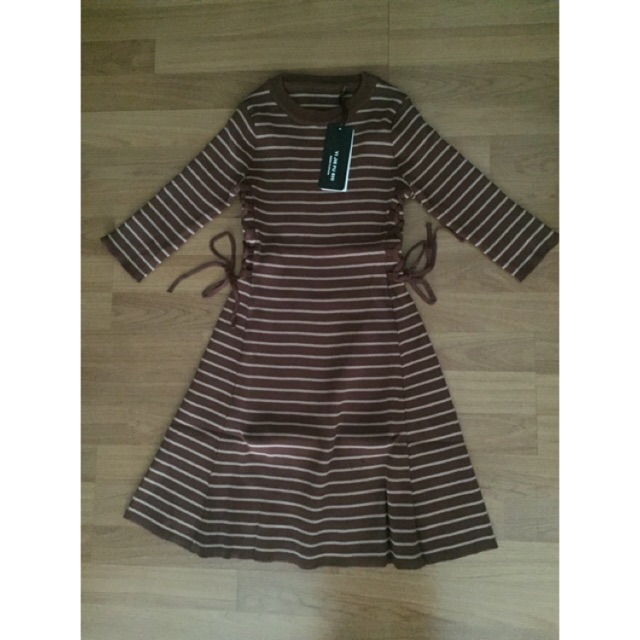 One-Hand Dress Brown Yarn And White Stripes. Decorated With A Bow At ...