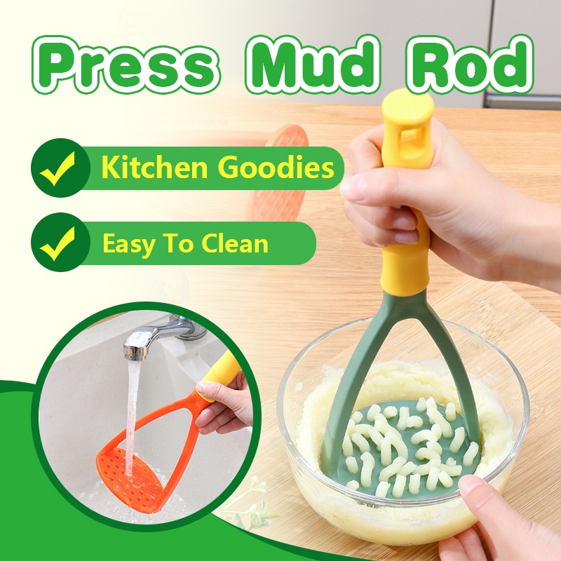 Baby complementary food grinder presses on mashed potatoes which are ...