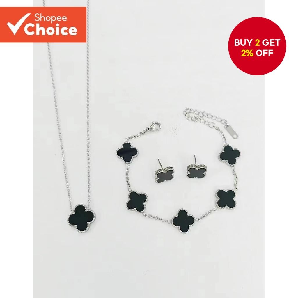 A silver titanium four-leaf clover jewelry set including a necklace ...