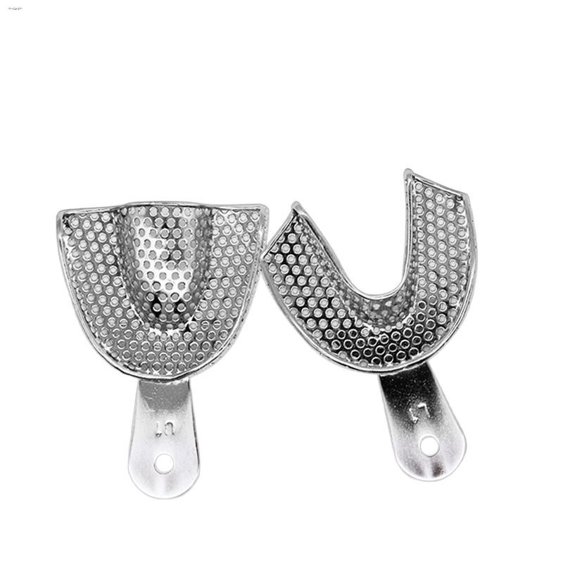 Dental stainless steel tooth tray with holes in the mouth to take the ...