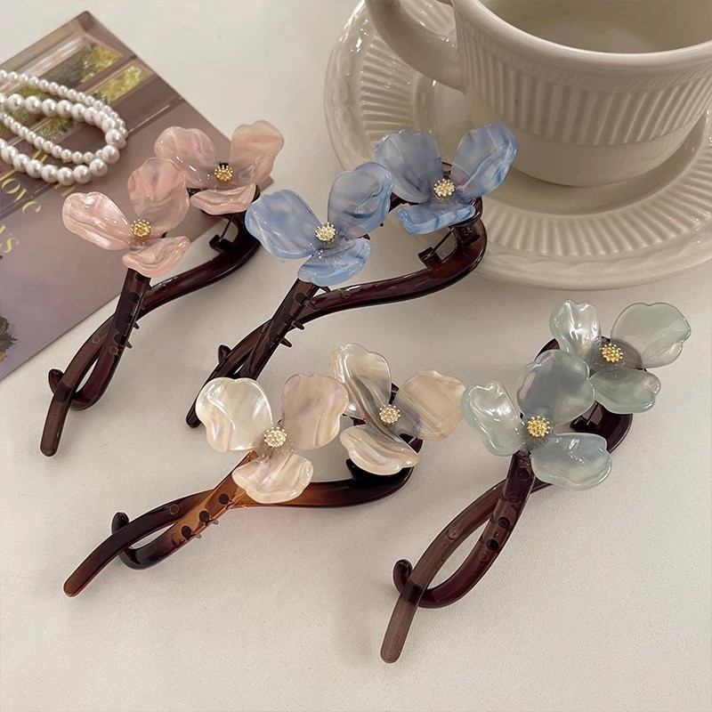A women's hair clip with delicate orchid flowers, twisted hair clip at ...