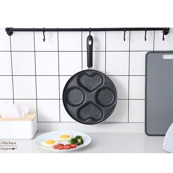 Non-stick frying pan divided into 4 heart-shaped and round compartments ...
