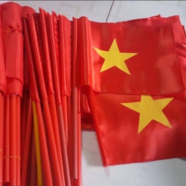 Waving flags, hand-held flags, red flags with yellow stars for opening ...