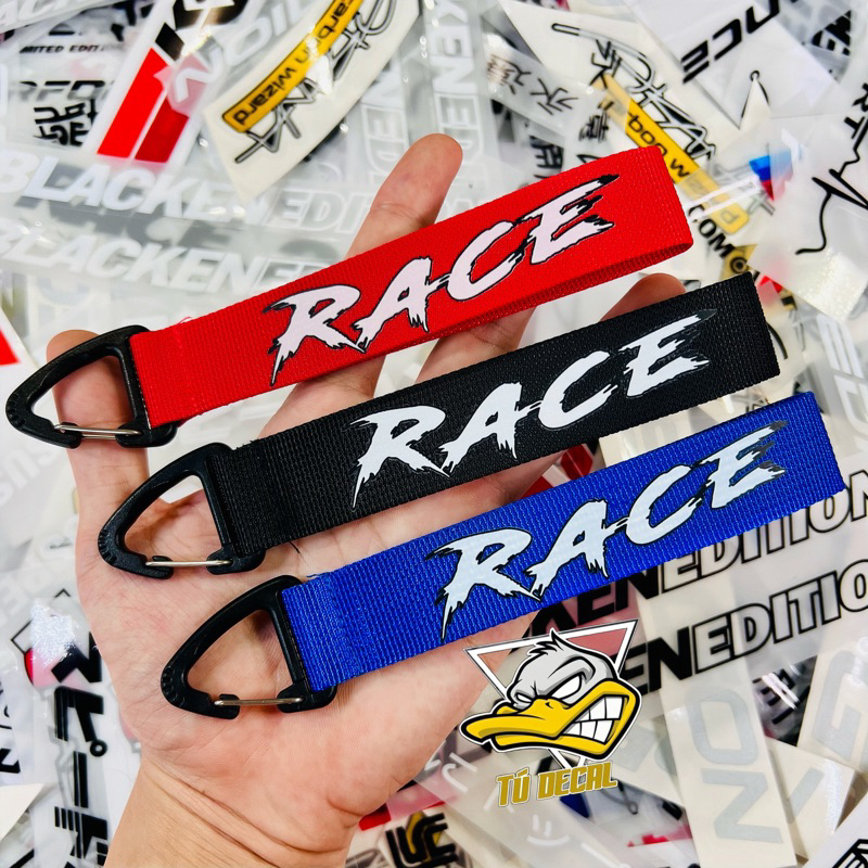Race string keychain, with three red, black and blue color combinations ...