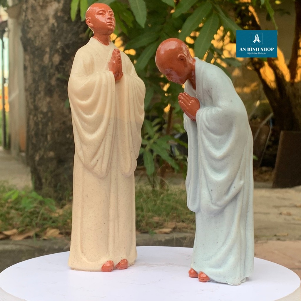 Statue of monk worshiping Buddha - standing and bowing position ...