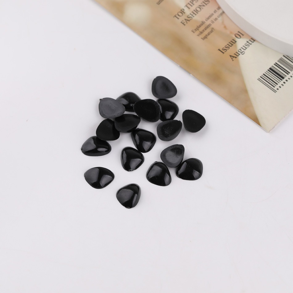 Stuffed animal noses, black plastic dolls with stickers of many sizes ...