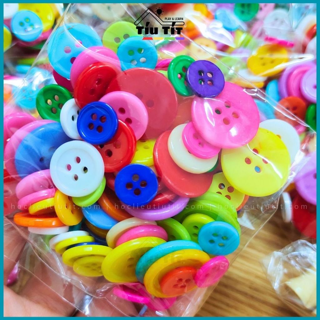Set of round plastic buttons in many colors and sizes for creative ...