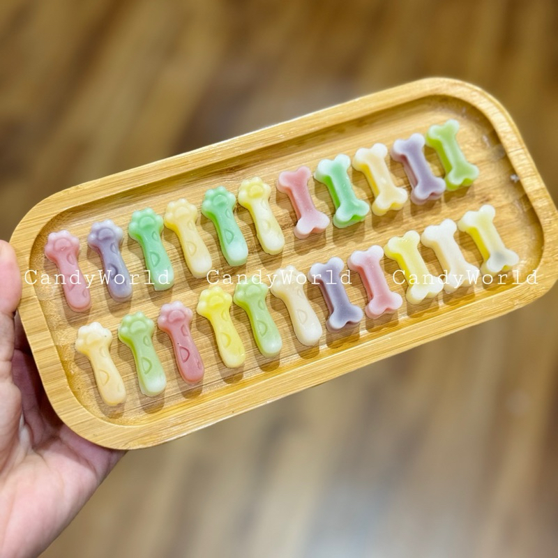 Beeswax candy shaped like cat paws and cute little dog bones filled ...