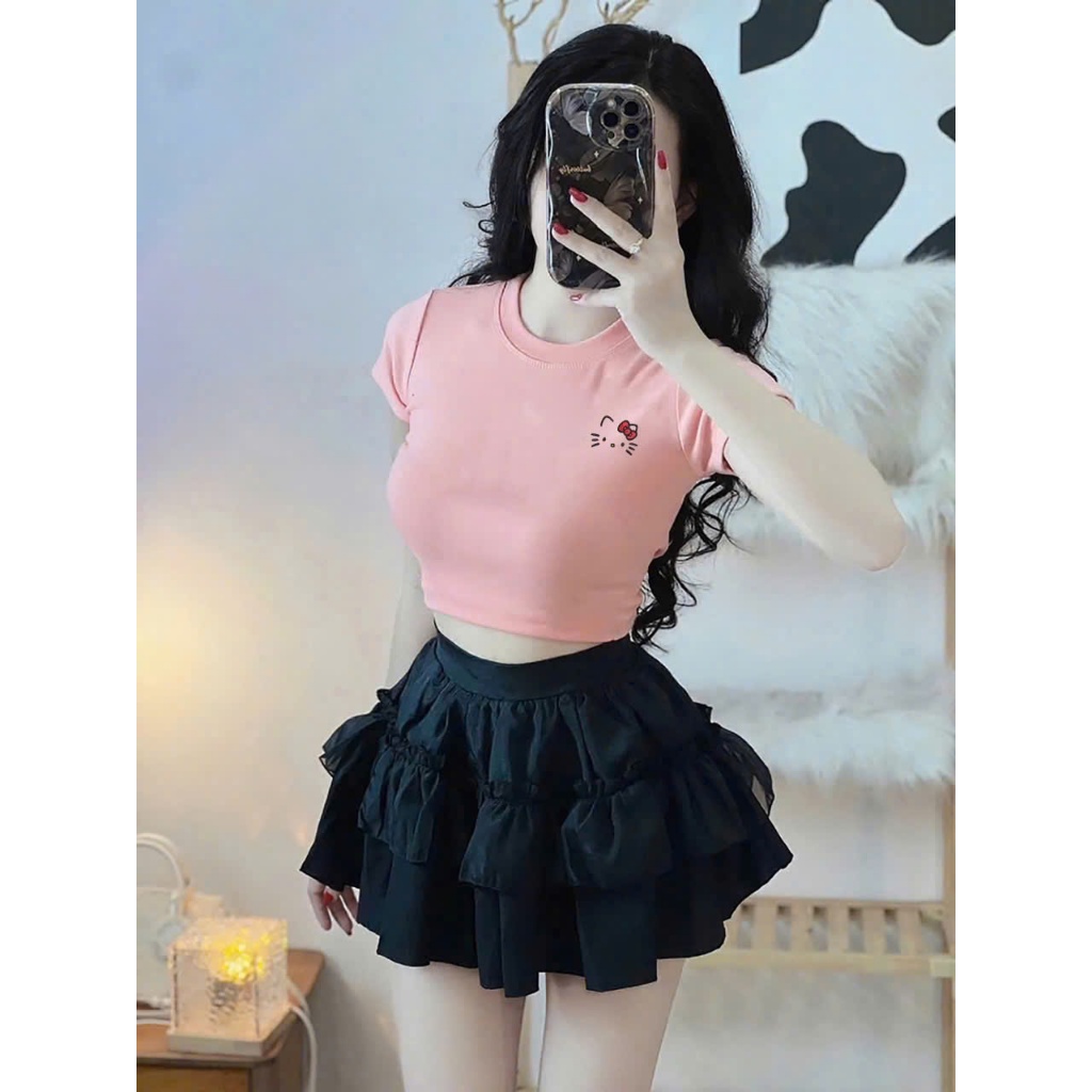 Very cute short-sleeved crop top with a small cat face printed on the ...