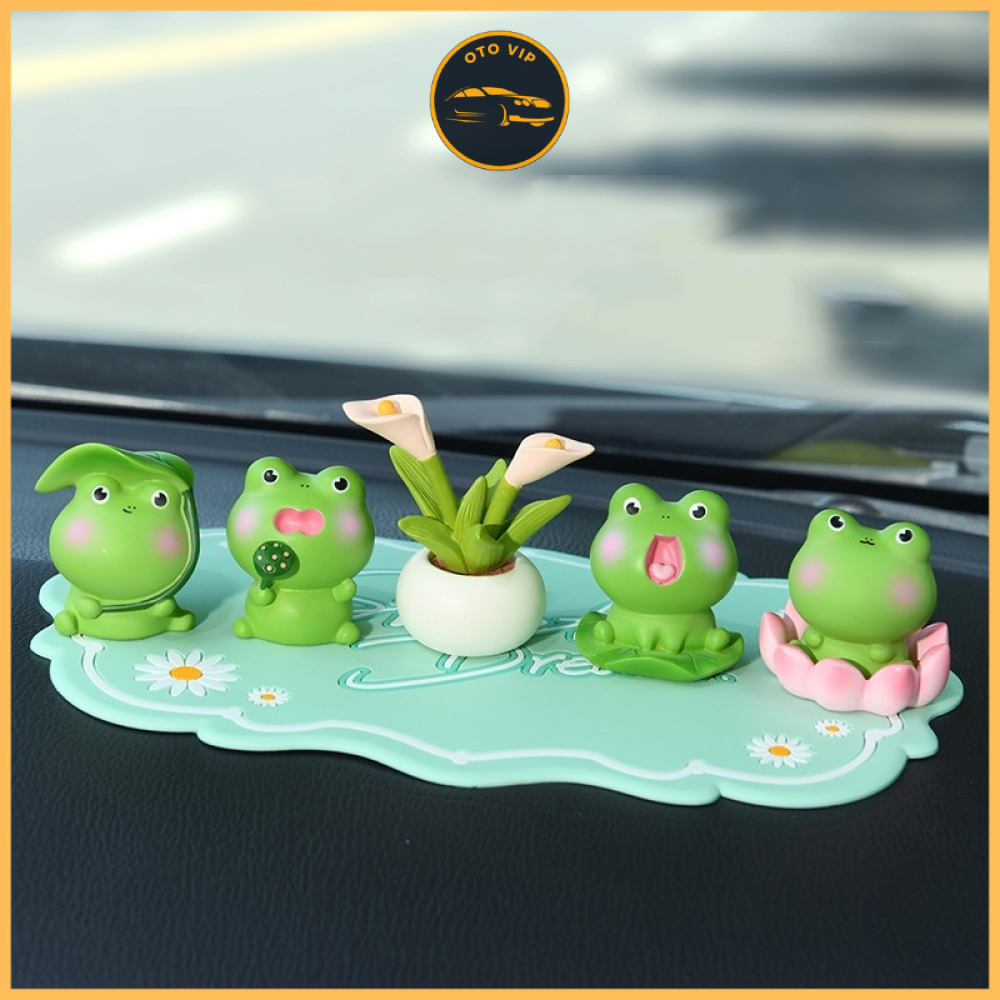 Mini green frog sitting on lotus leaf decorates car dashboard, cute ...